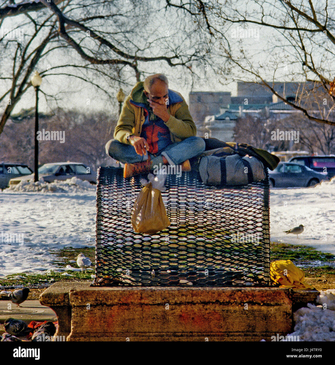 A homeless person trying to keep warm is seen camping out on top of a ...