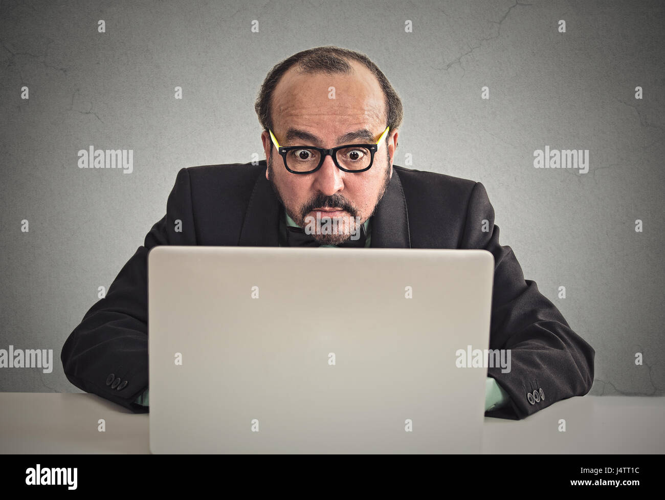 businessman looking concentrated on computer screen trying to solve a ...