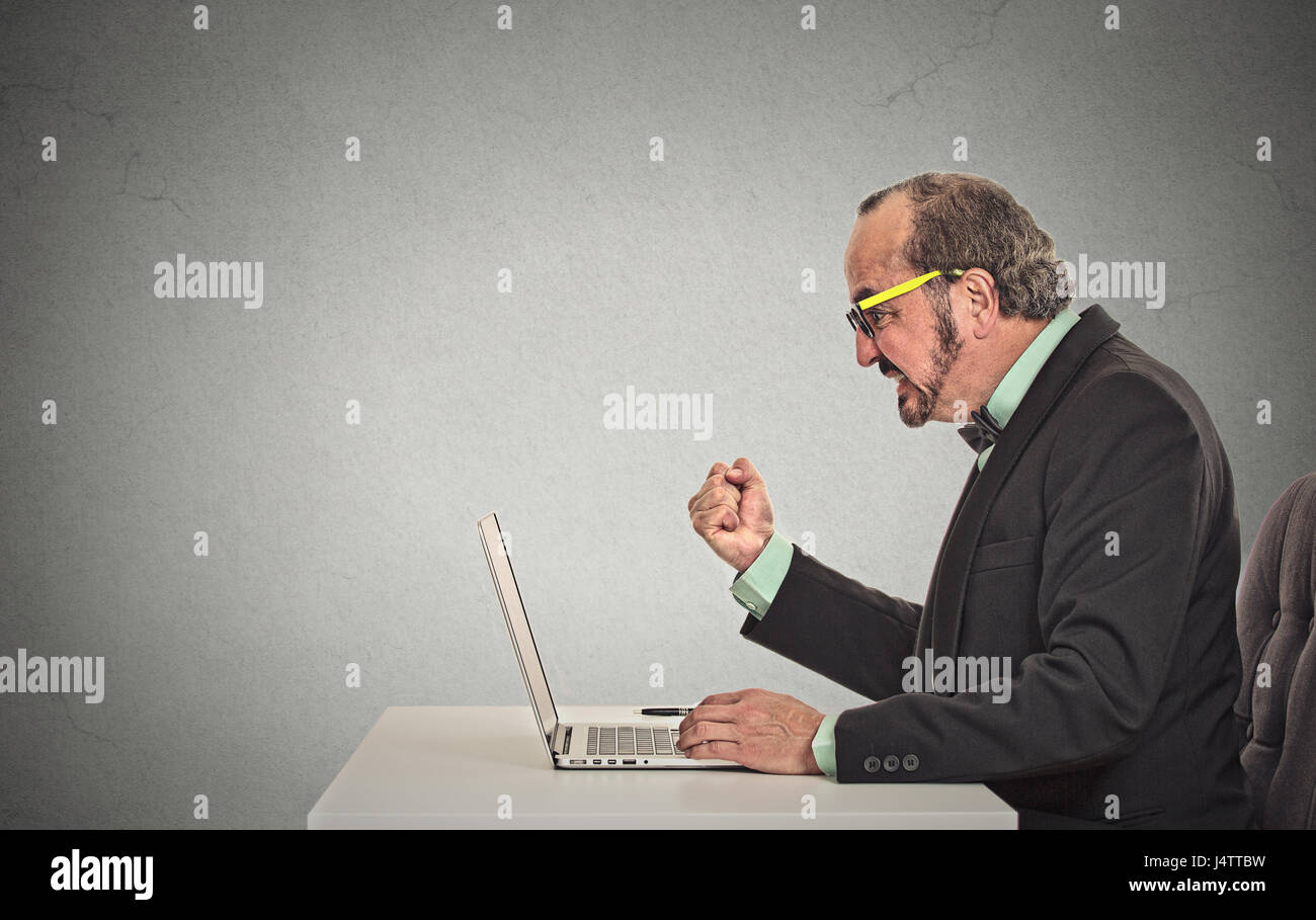 Side profile man angry frustrated annoyed at computer. Problems with ...