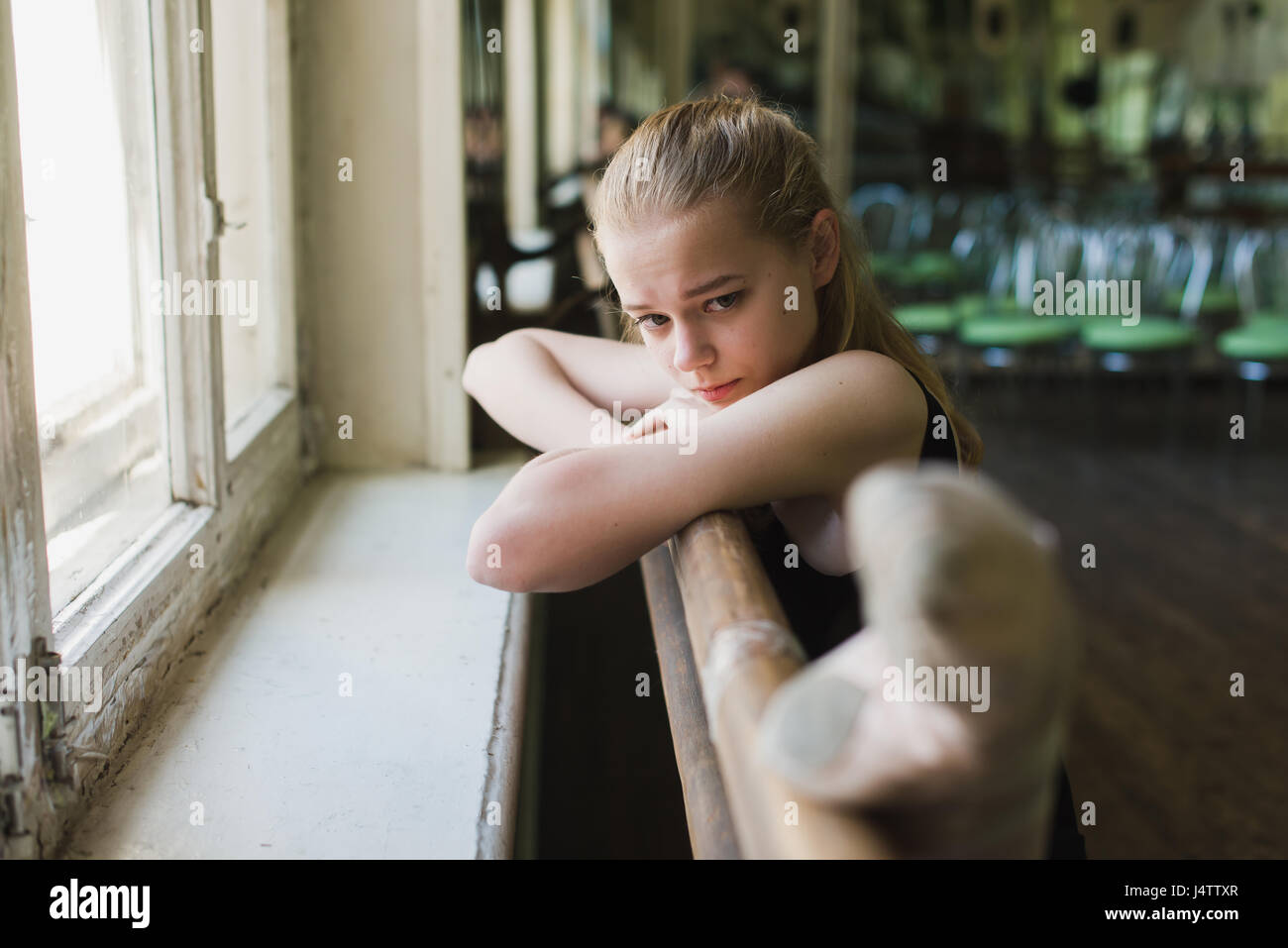 Young beautiful ballerina dancer warming up in ballet class. Girl ...