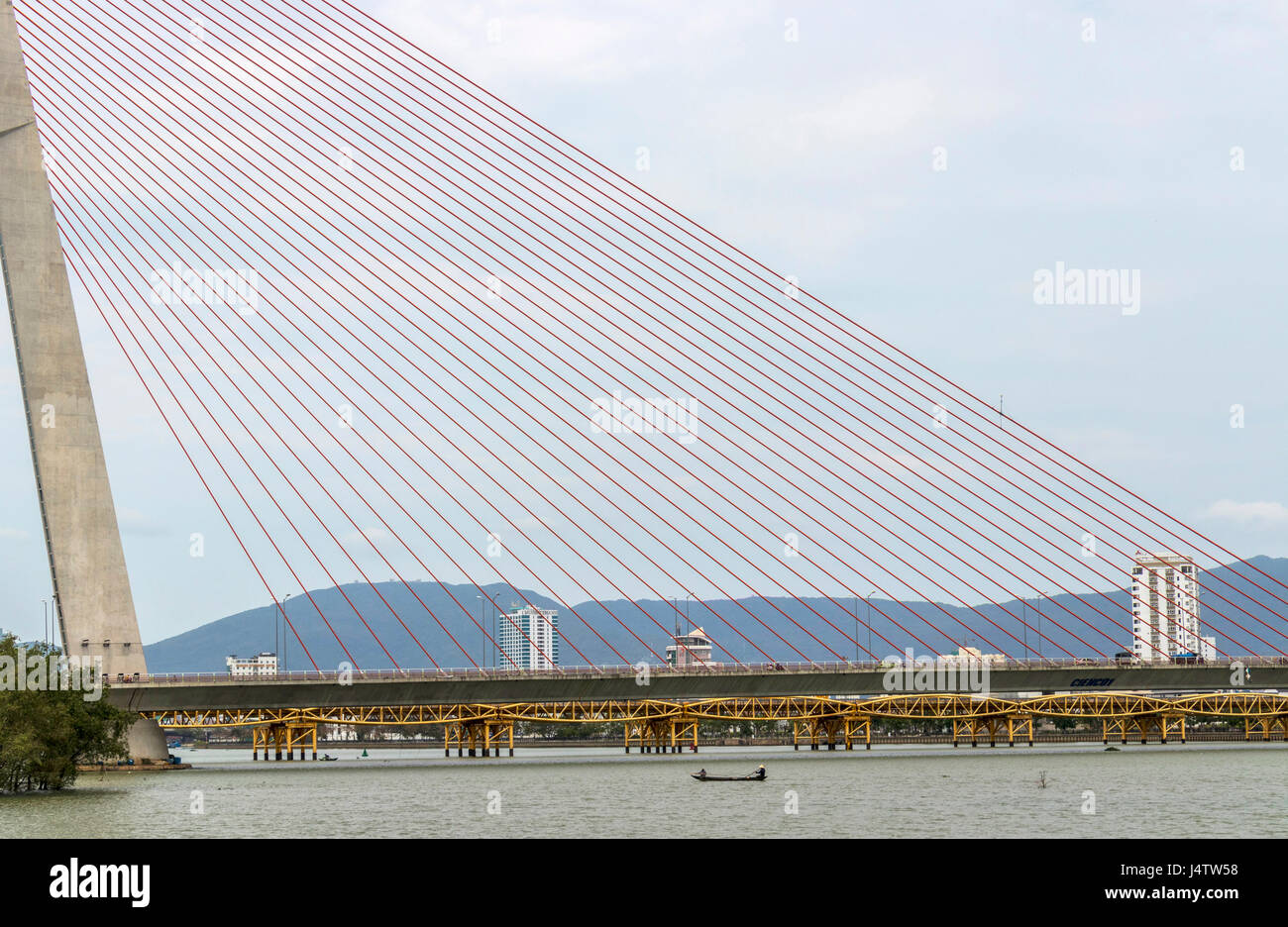 Boat passing suspension bridge on Song Han river Danang central Vietnam ...