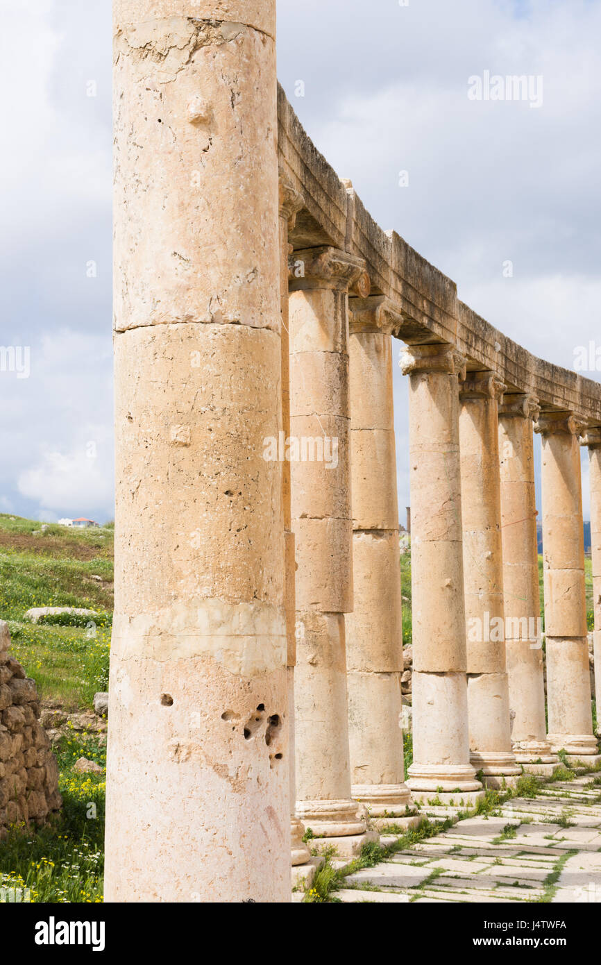 Ancient carved stone columns with ornate capitals and stone lintels or ...