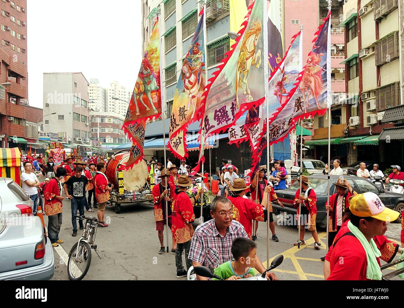 KAOHSIUNG, TAIWAN -- APRIL 20, 2014: A religious procession with flags ...