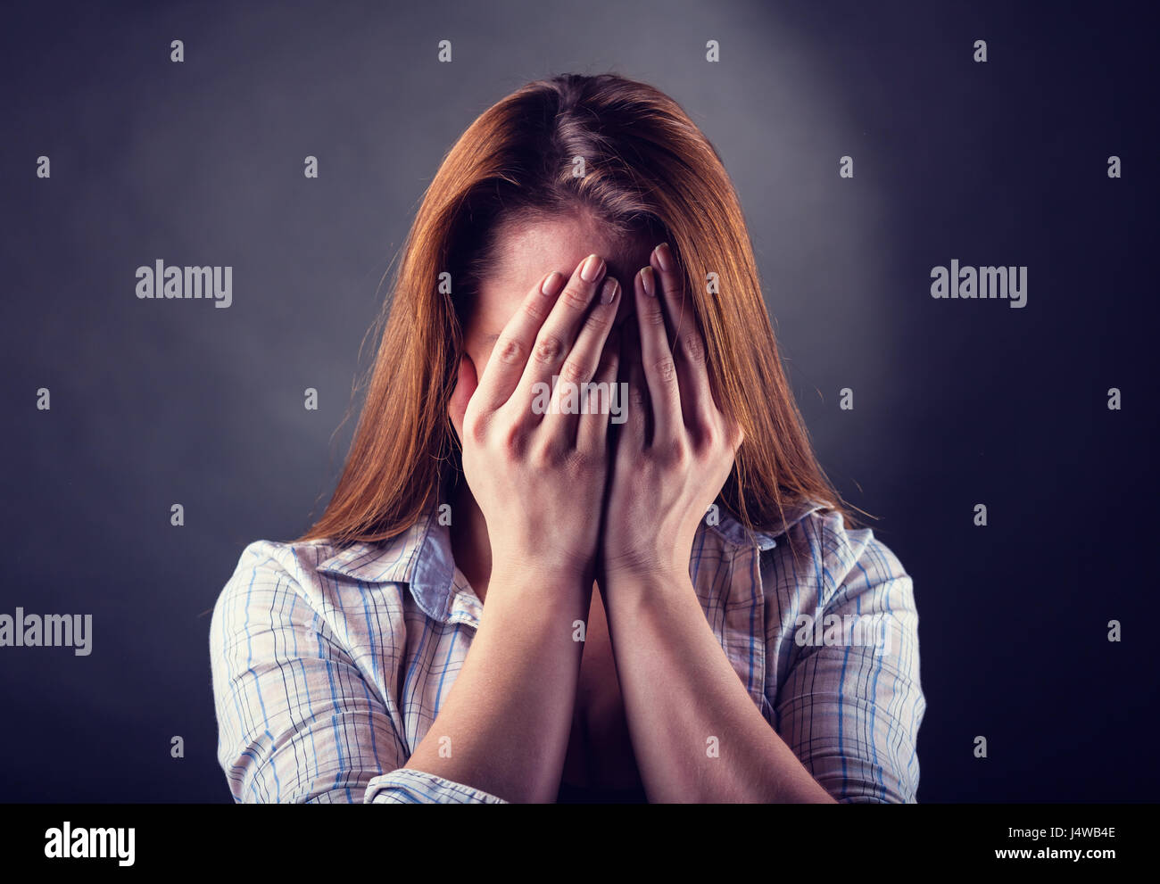 Crying woman on a dark background Stock Photo - Alamy