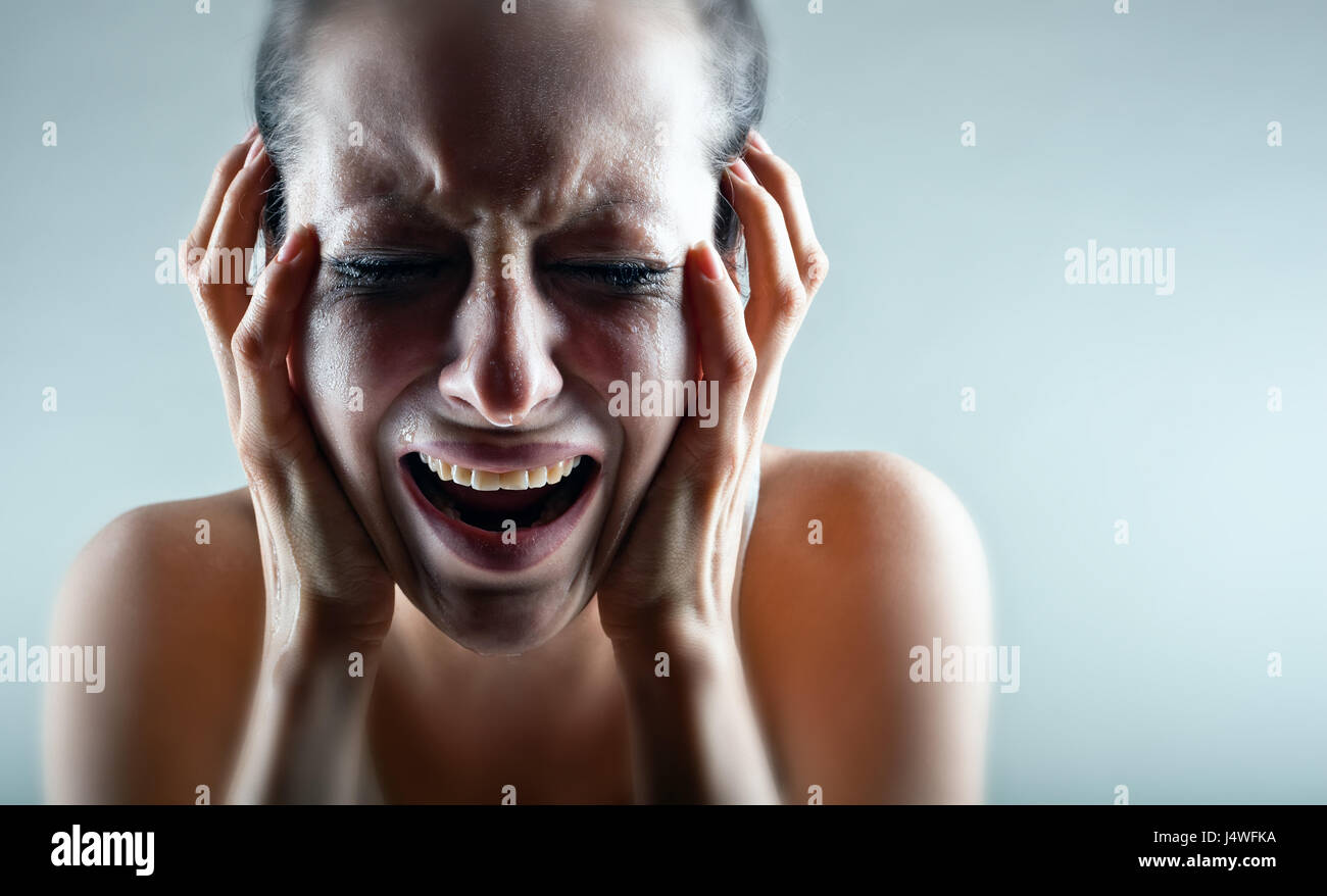 Crying woman on a light background Stock Photo - Alamy