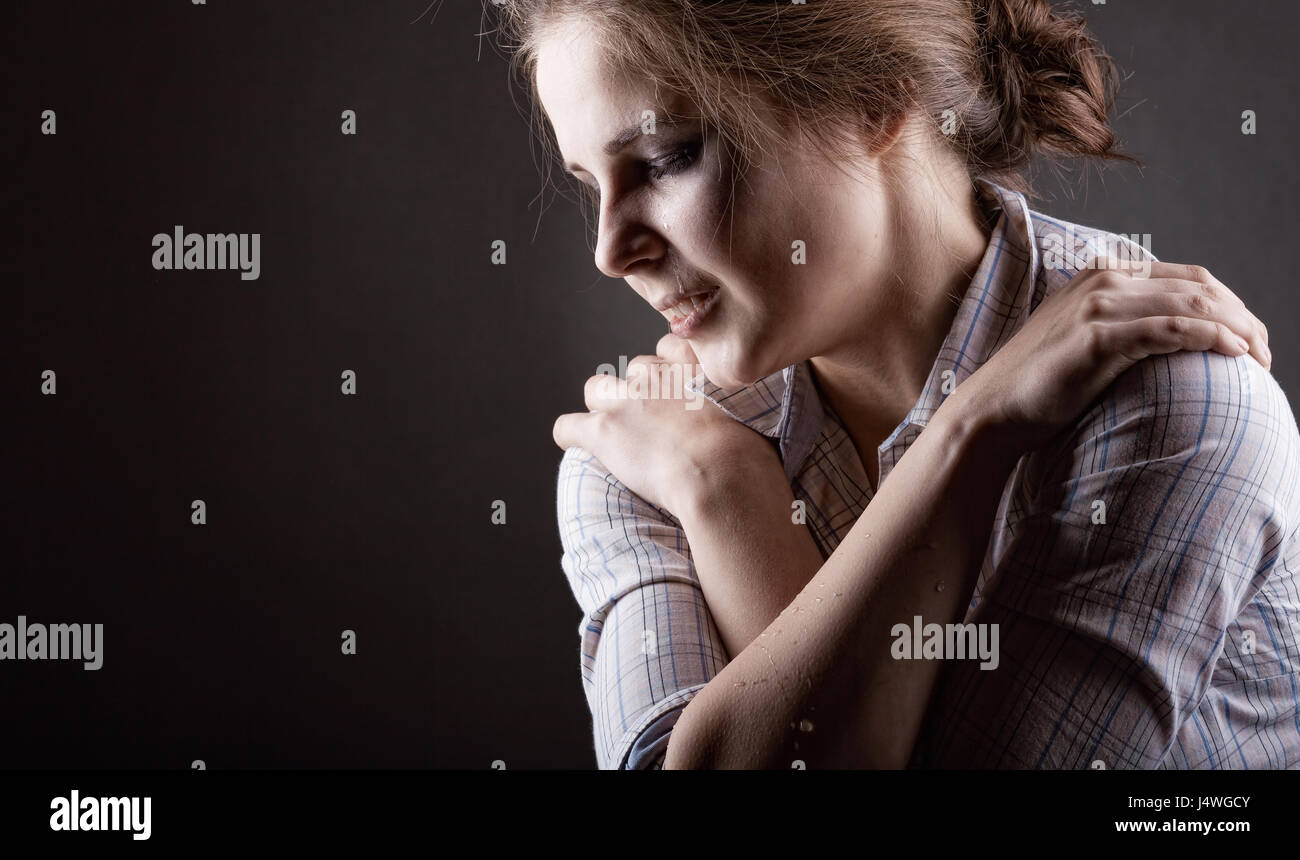 Young woman desperately crying on a dark background Stock Photo - Alamy