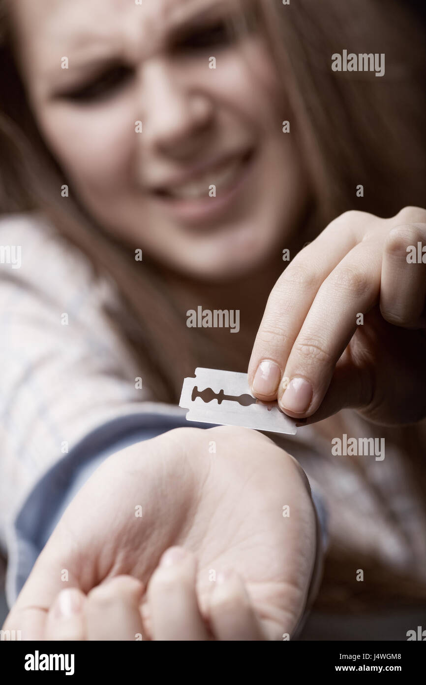 Young woman cuts veins on a hand. Focus on hand Stock Photo - Alamy