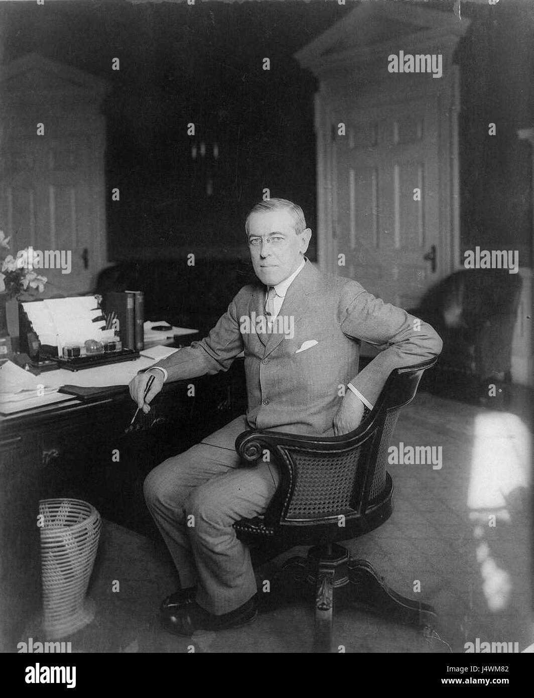 This photograph shows U.S. President Woodrow Wilson seated at his desk ...