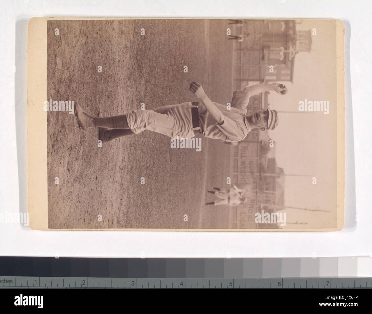 This image features an unidentified baseball player in pitching form ...