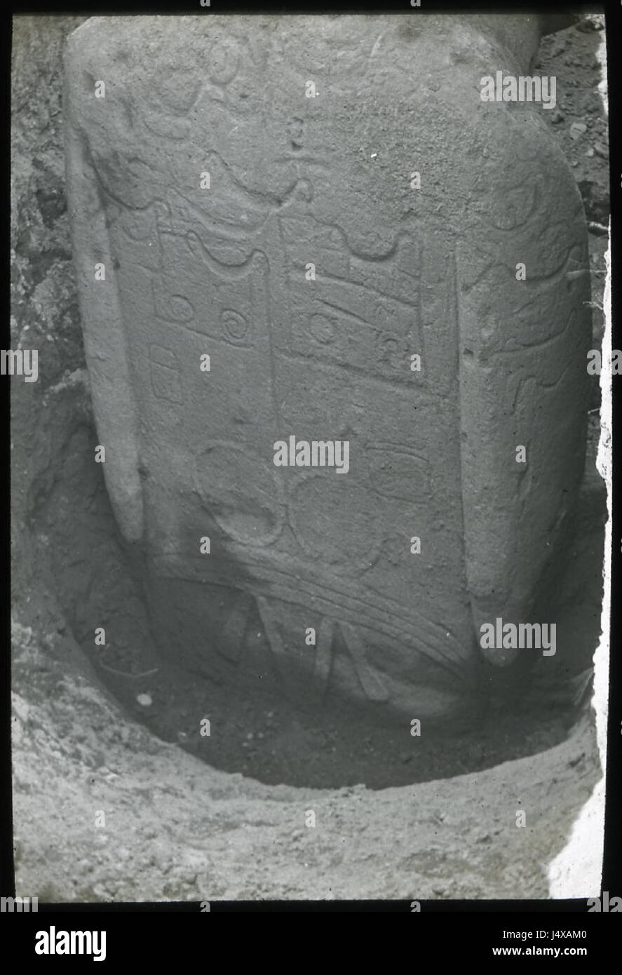 View of the back of a moai, excavated, standing upright in the ground ...