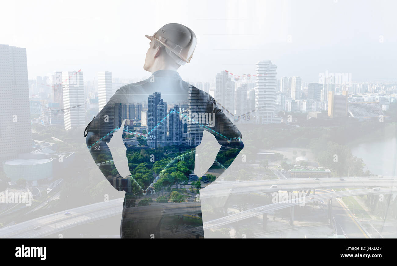 Engineer man standing with back and drawing blueprints. Mixed media ...