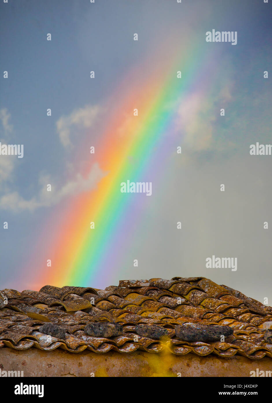Rainbow over tiled roof in Sicily Stock Photo - Alamy