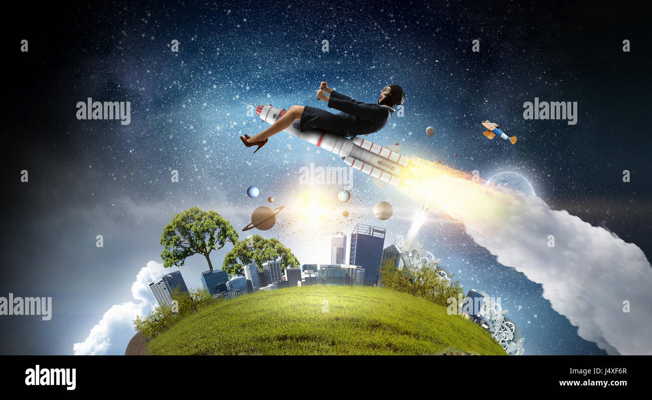 Young woman pilot in helmet flying on rocket. Mixed media Stock Photo ...