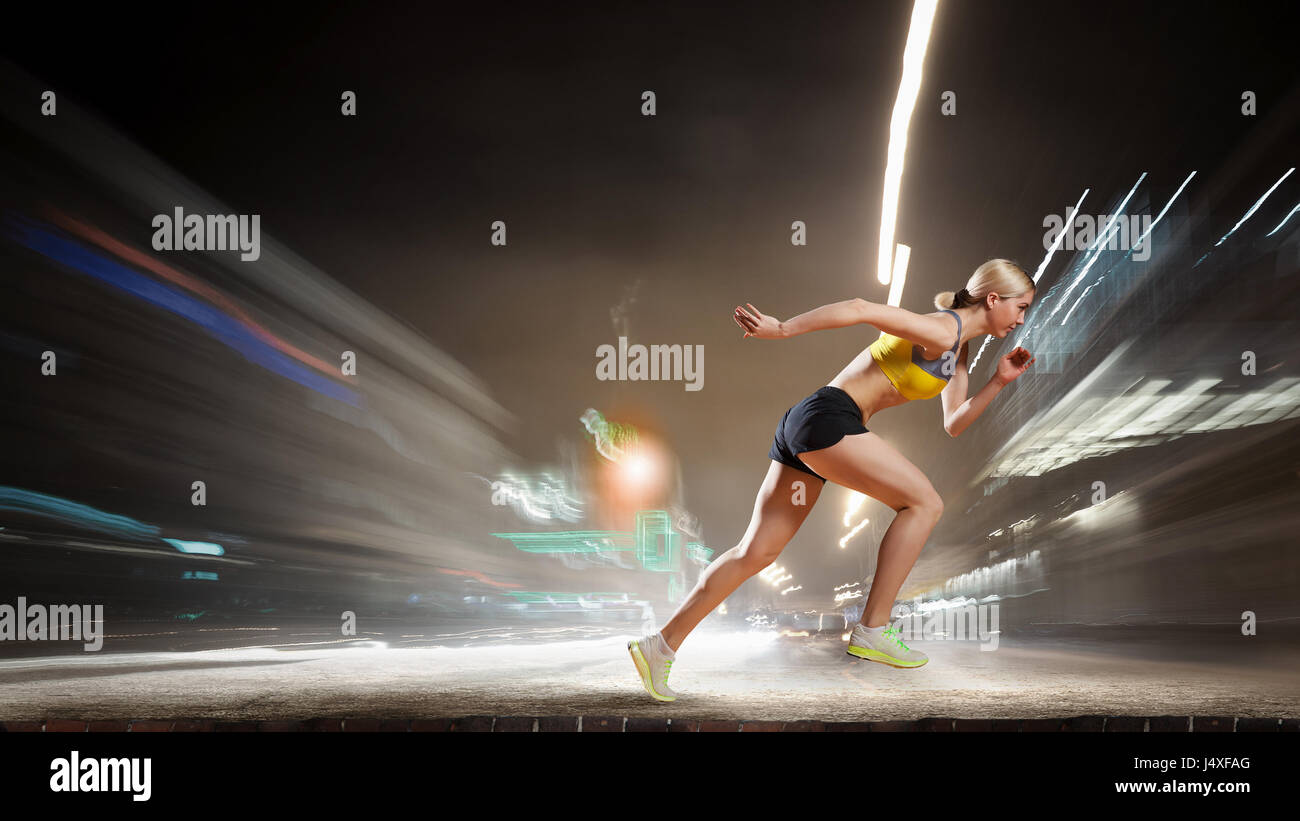 Slim attractive sportswoman running fast. Mixed media Stock Photo - Alamy