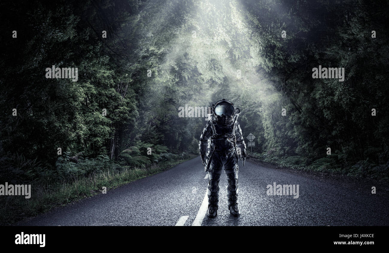 Explorer in astronaut suit in natural landscape. Mixed media Stock ...
