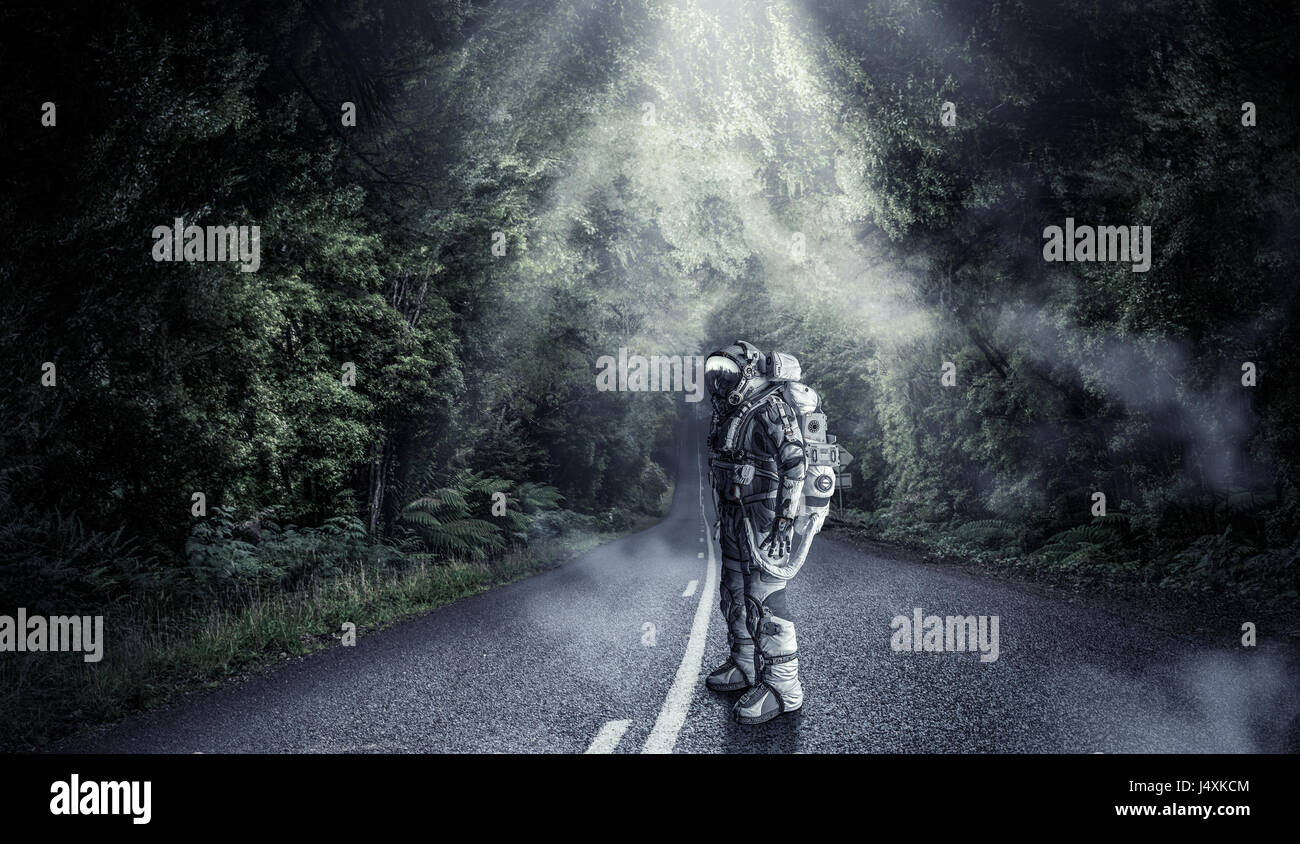 Explorer in astronaut suit in natural landscape. Mixed media Stock ...
