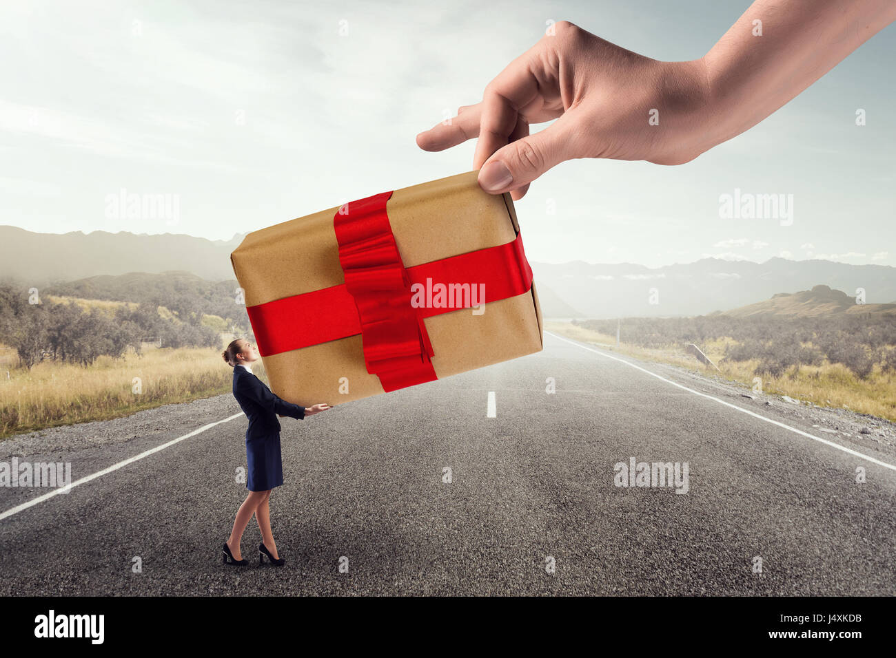 Young woman carrying gift box in her hands Stock Photo - Alamy