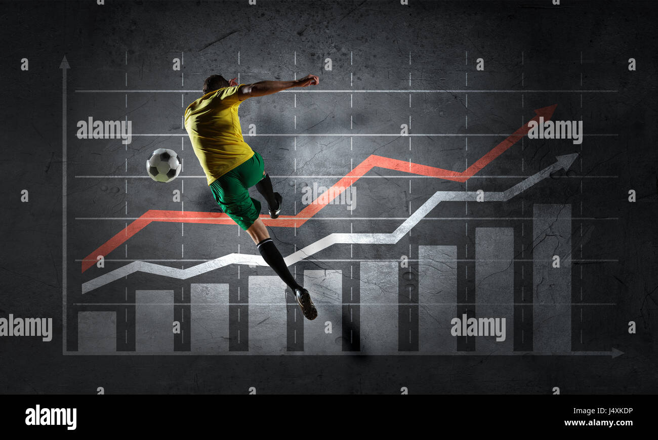 Football player kicking ball and graphs at background. Mixed media ...