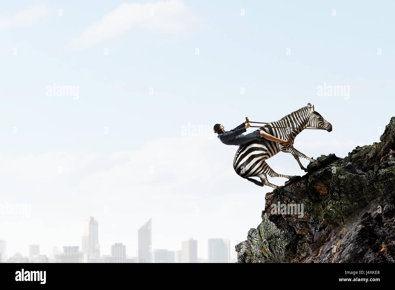 Young pretty fearless woman riding zebra animal Stock Photo - Alamy