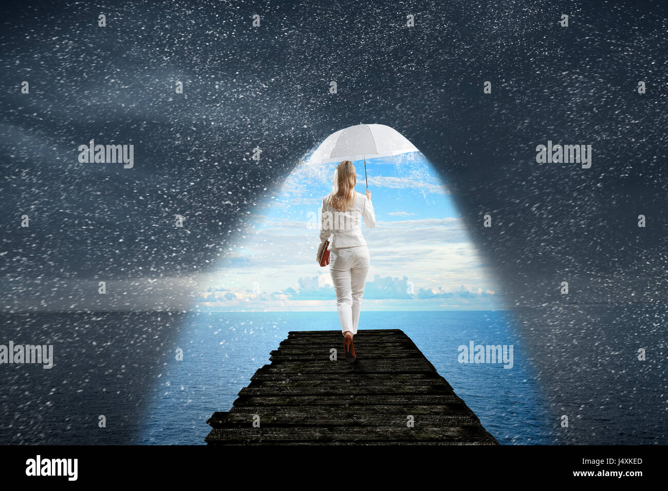 Elegant businesswoman hiding from rain under umbrella Stock Photo - Alamy