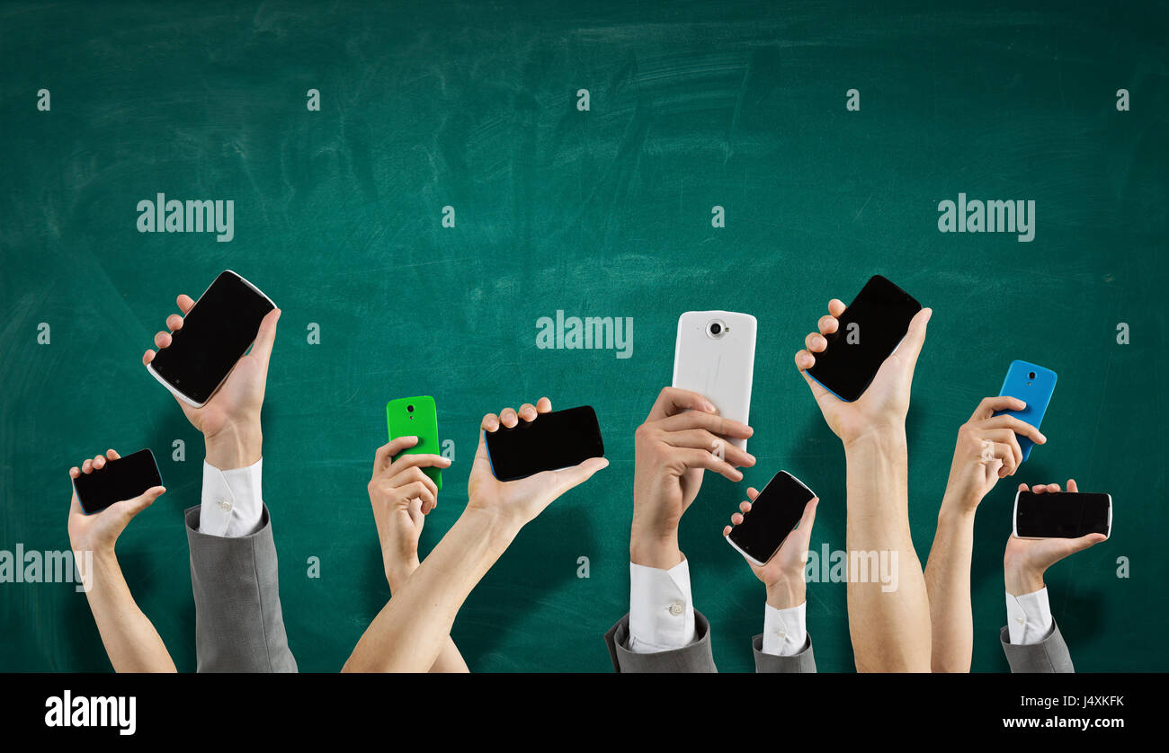 Many people in row raising upward hands showing mobile phones Stock ...