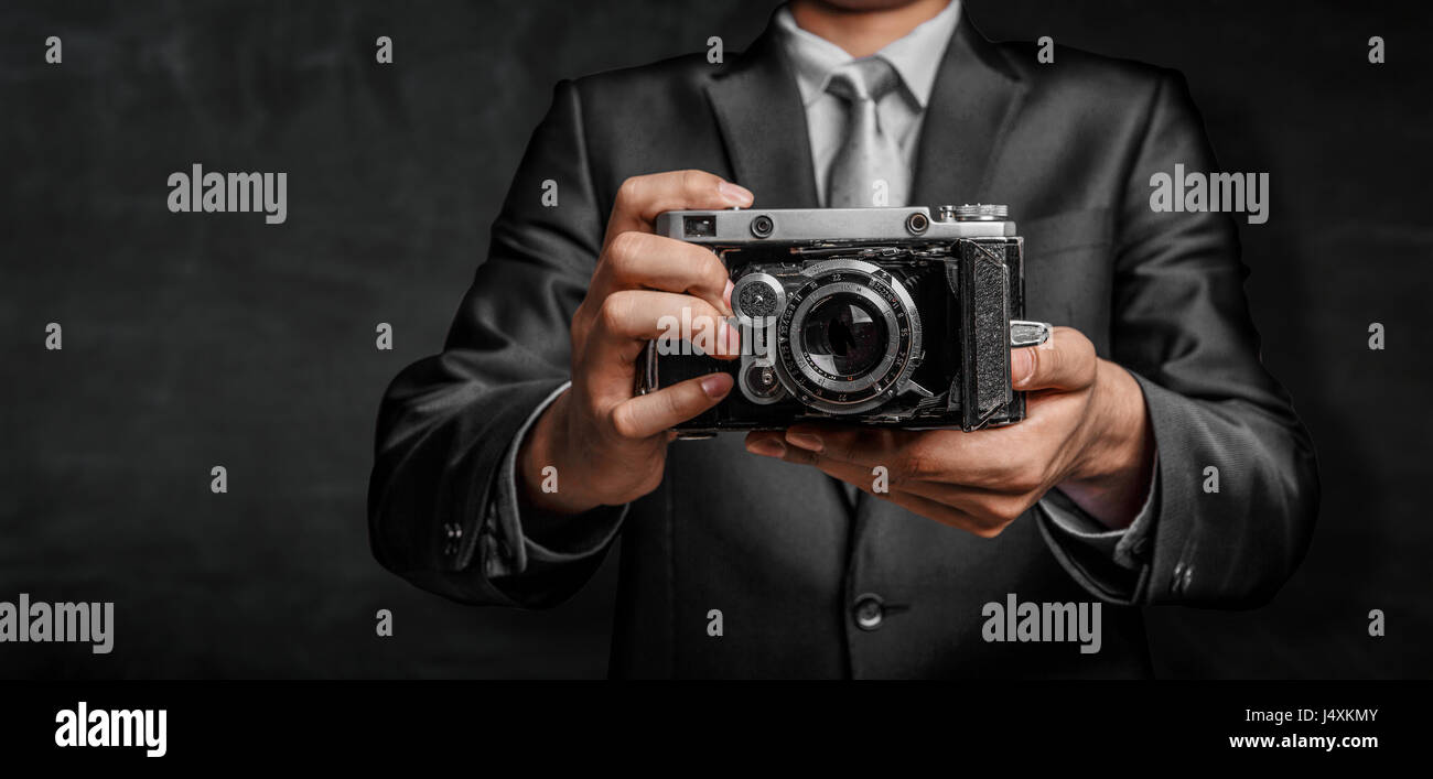 Chest view of businessman taking photo with vintage camera Stock Photo ...