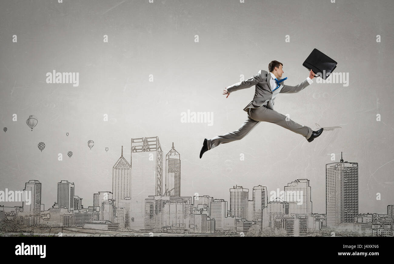 Happy businessman jumping high in sky to celebrate success Stock Photo ...