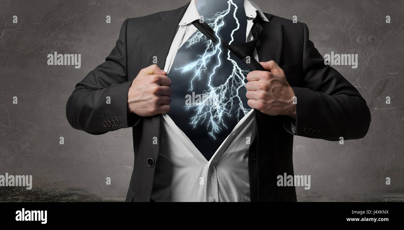 Businessman opening his chest and acting like super hero Stock Photo ...
