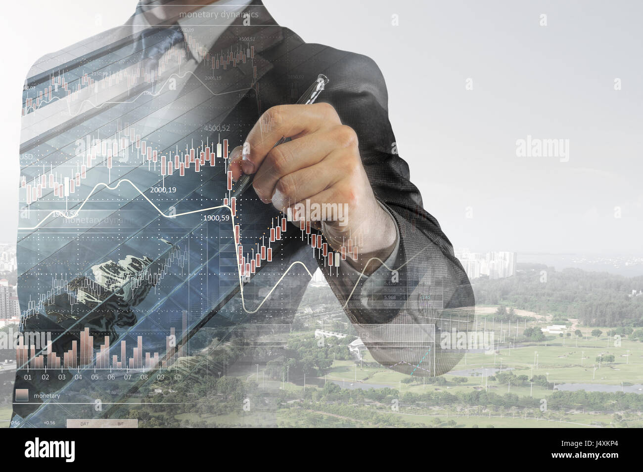 Businessman drawing graph on screen and modern cityscape on the ...