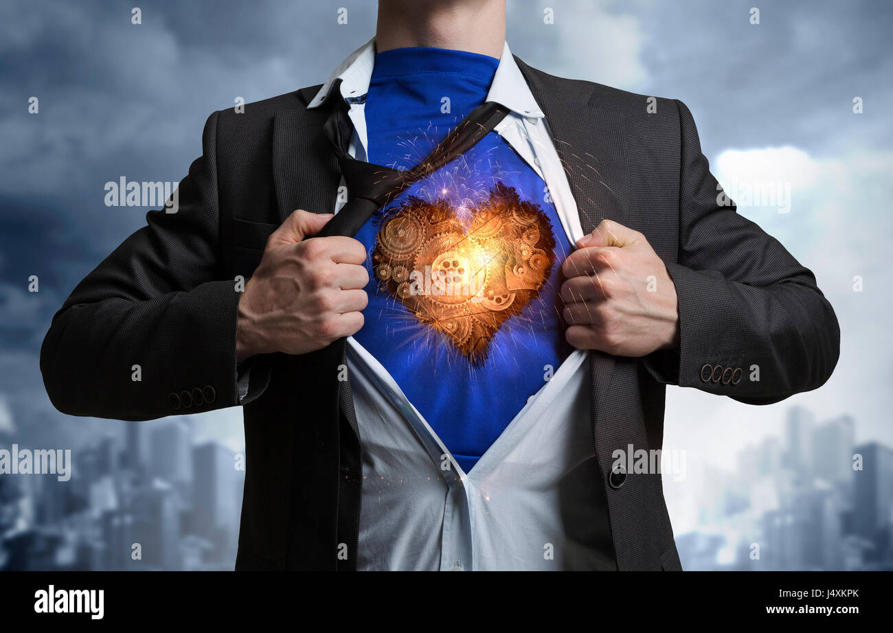 Businessman opening his chest and acting like super hero Stock Photo ...