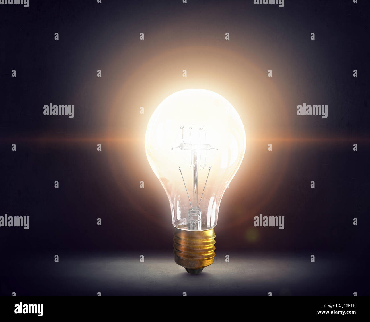 Glowing bright light bulb on dark background Stock Photo - Alamy