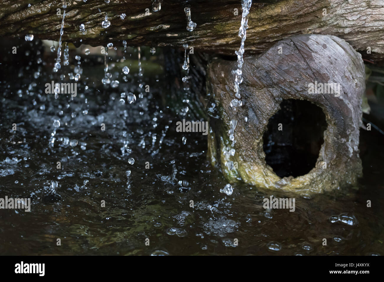 Small artificial waterfall in the garden Stock Photo - Alamy