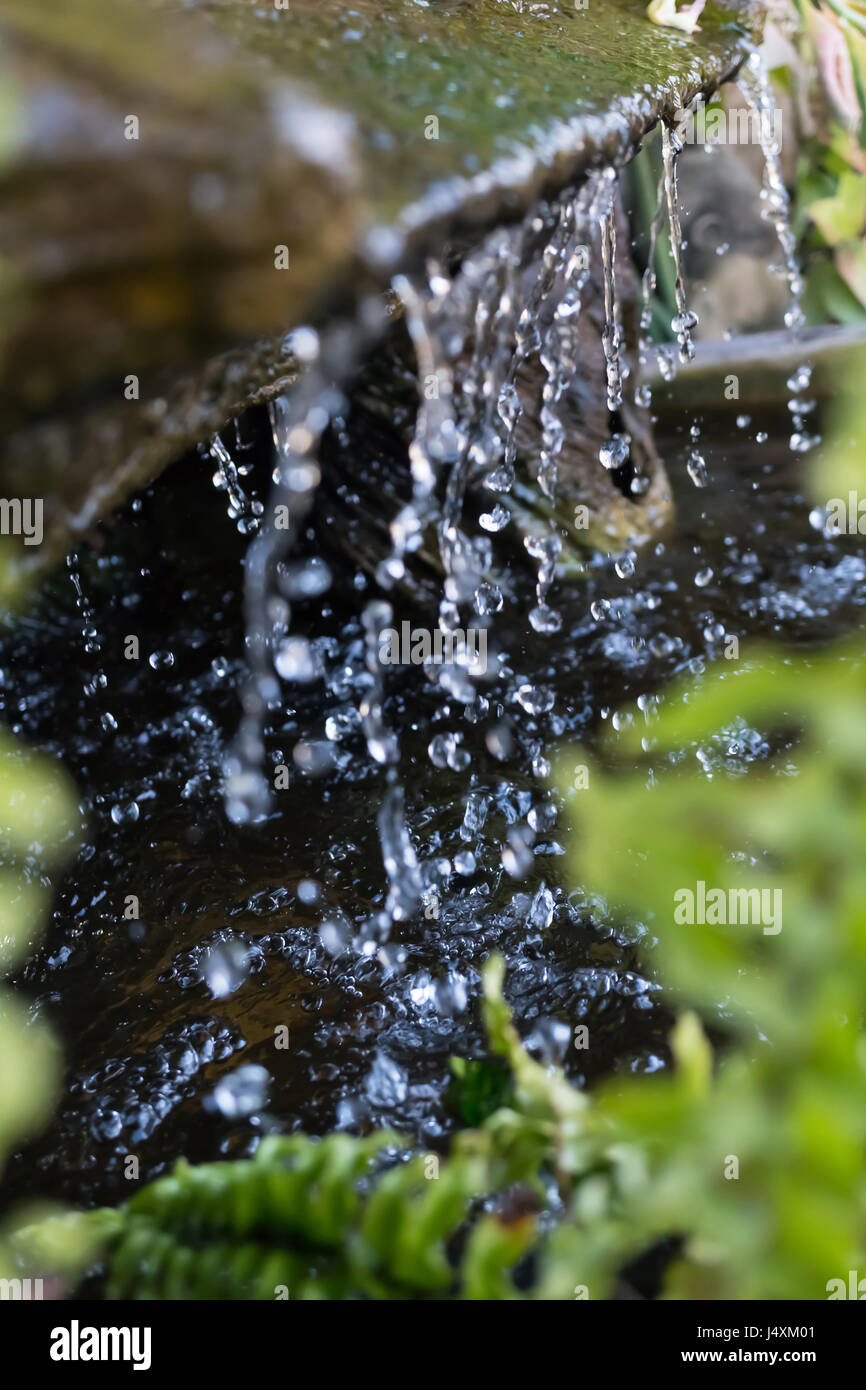 Small artificial waterfall in the garden Stock Photo - Alamy