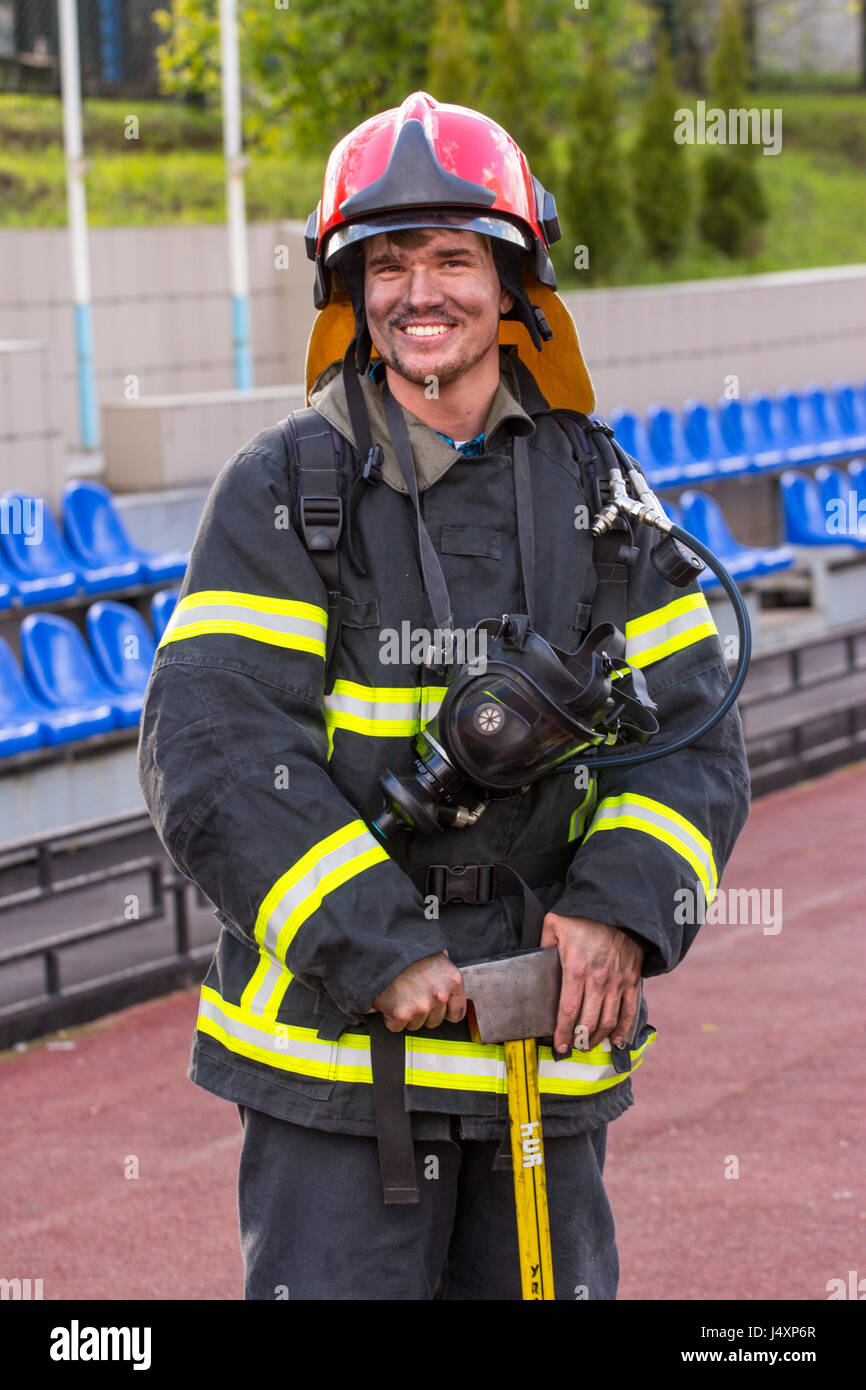 Portrait of heroic fireman with an axe outdoors Stock Photo - Alamy
