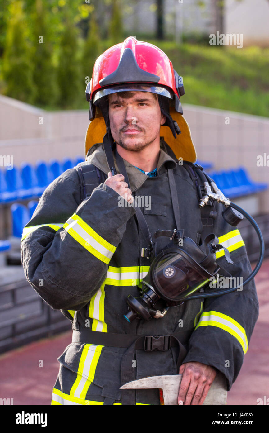 Portrait of heroic fireman with an axe outdoors Stock Photo - Alamy