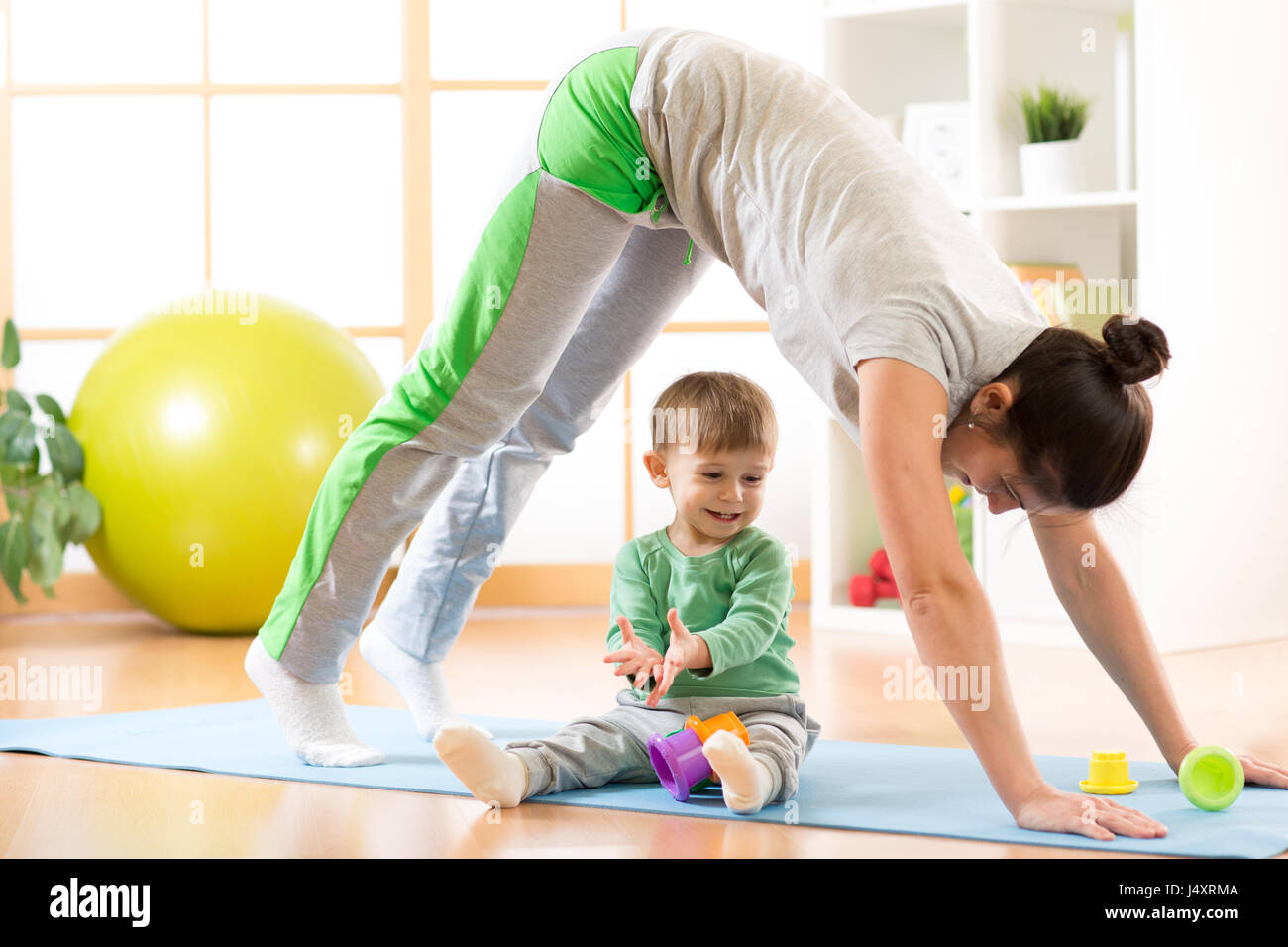 mother doing yoga or fitness exercises with baby Stock Photo - Alamy