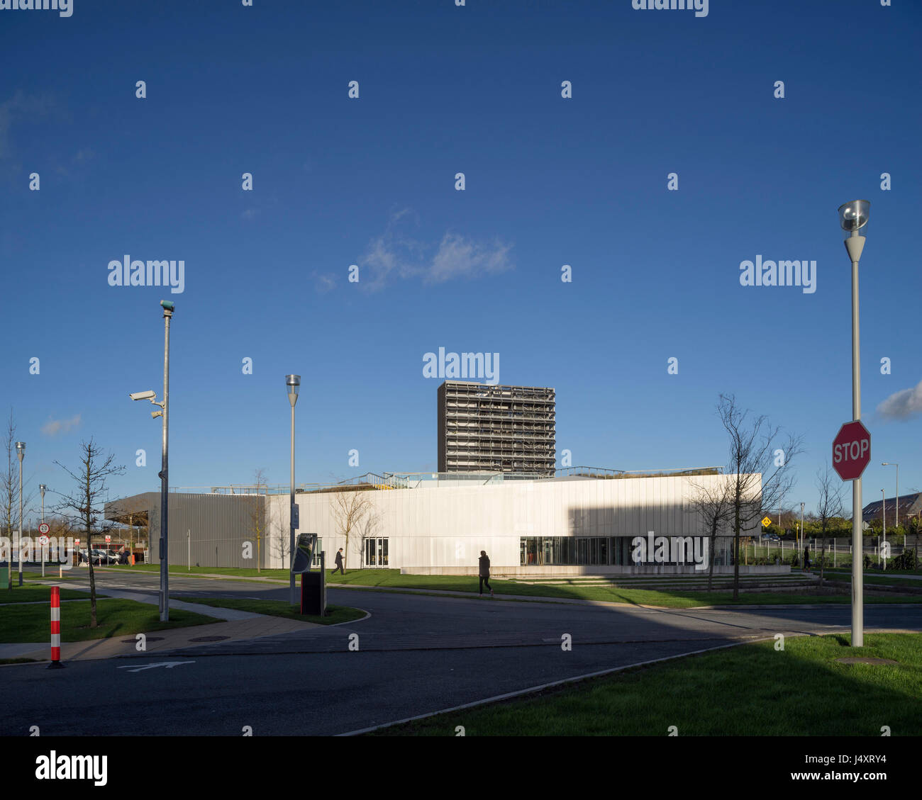 Distant view from street towards building complex with service tower ...