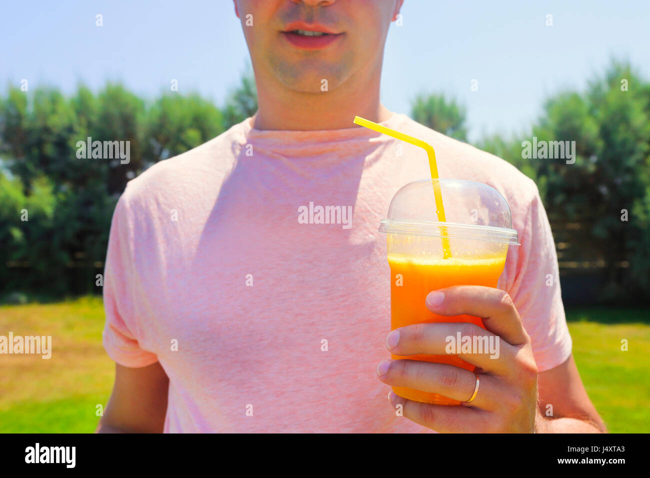 Man drinking vegetable smoothie after fitness running workout on summer ...