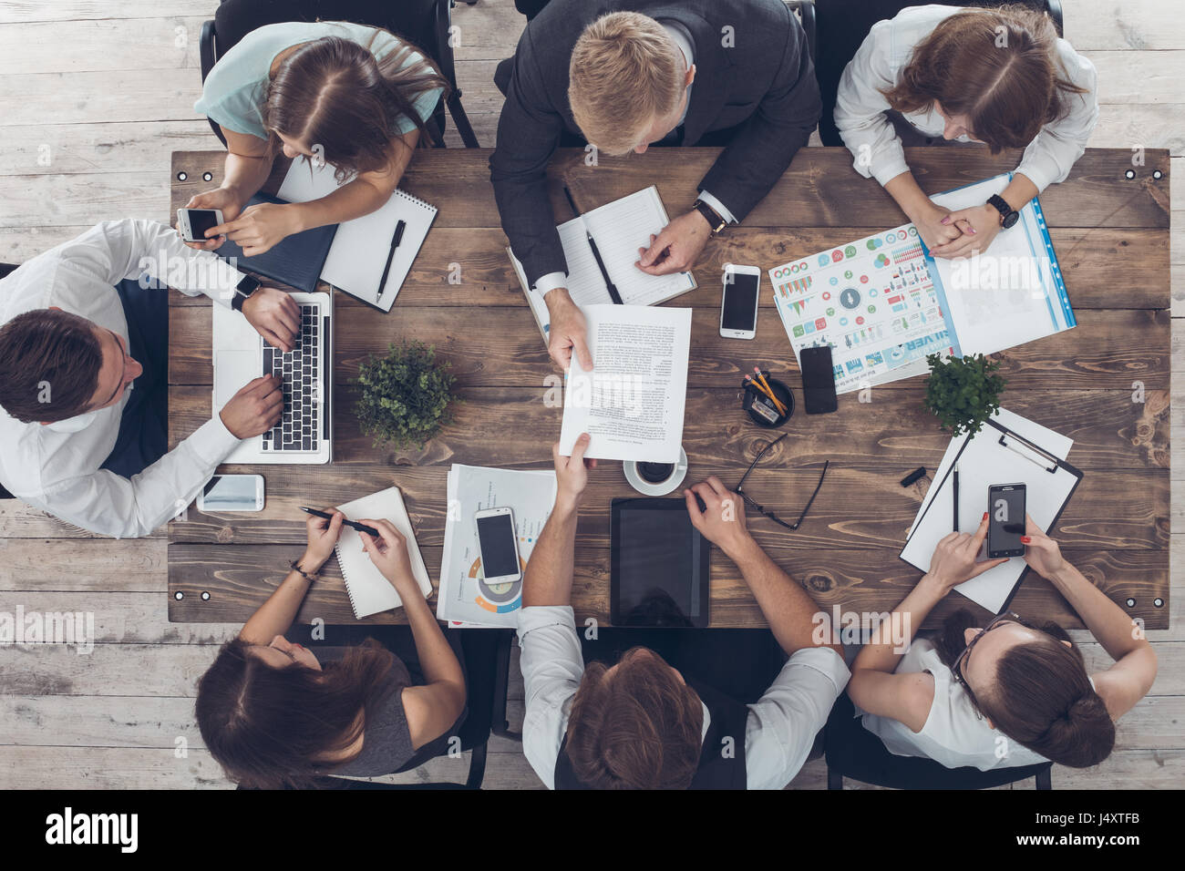 Business people man and women meeting in the office top view using ...