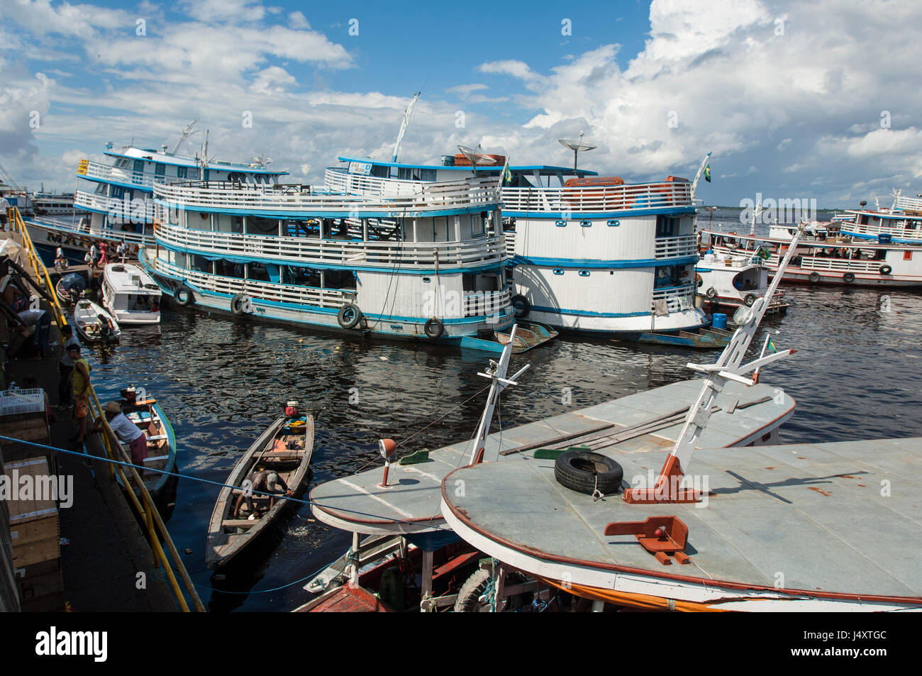 Numerous passenger ferries moored at the terminal quay on the Amazon ...