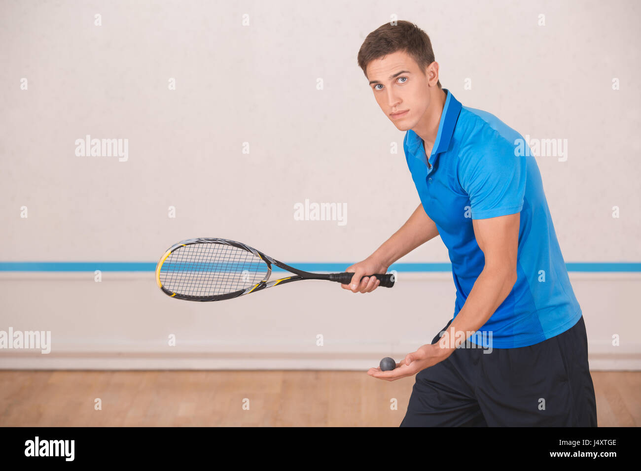 Young man squash player exercise game in the gym Stock Photo - Alamy