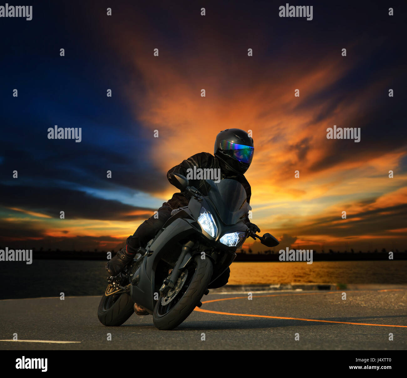 young man riding big bike motorcycle leaning curve on asphalt highways ...