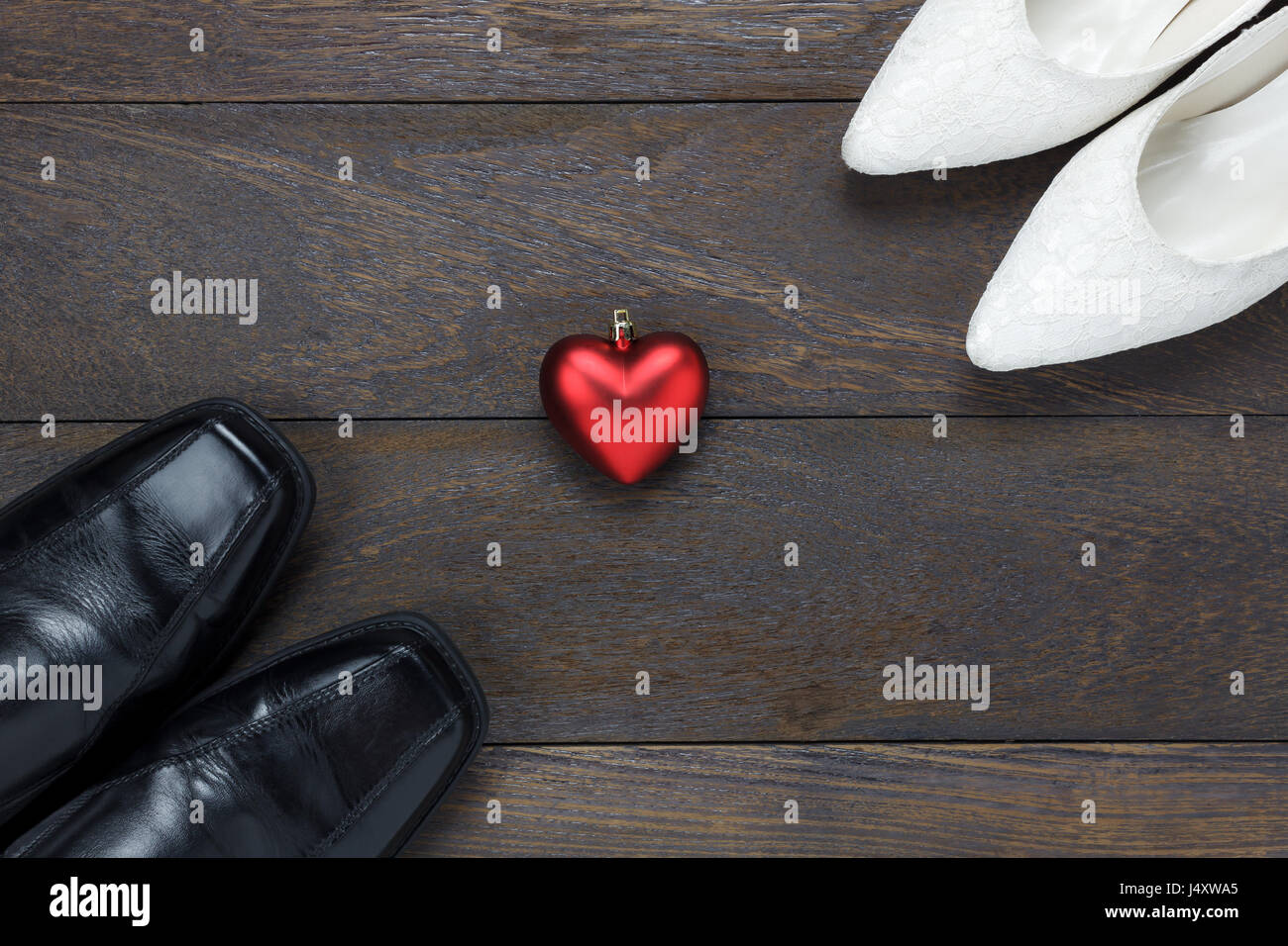 Top view heart shape with men's shoes and women's shoes on wooden ...