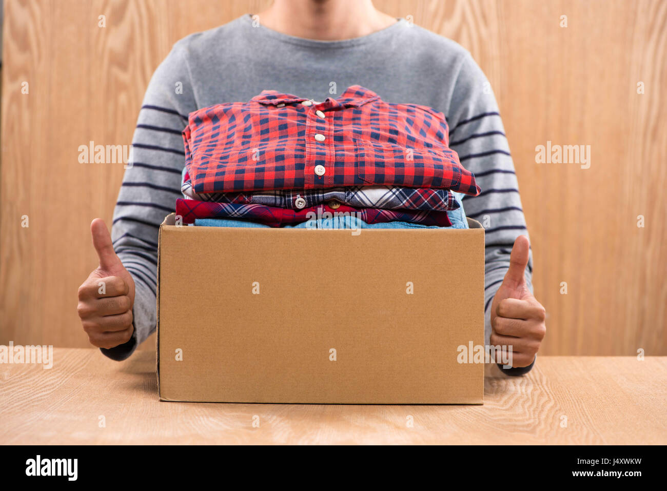 Donation box for poor with clothing in male hands Stock Photo - Alamy
