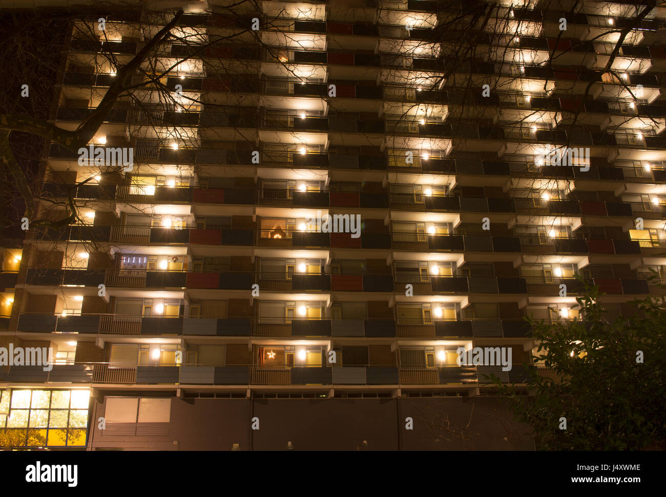 Apartment building at night, with lights Stock Photo - Alamy