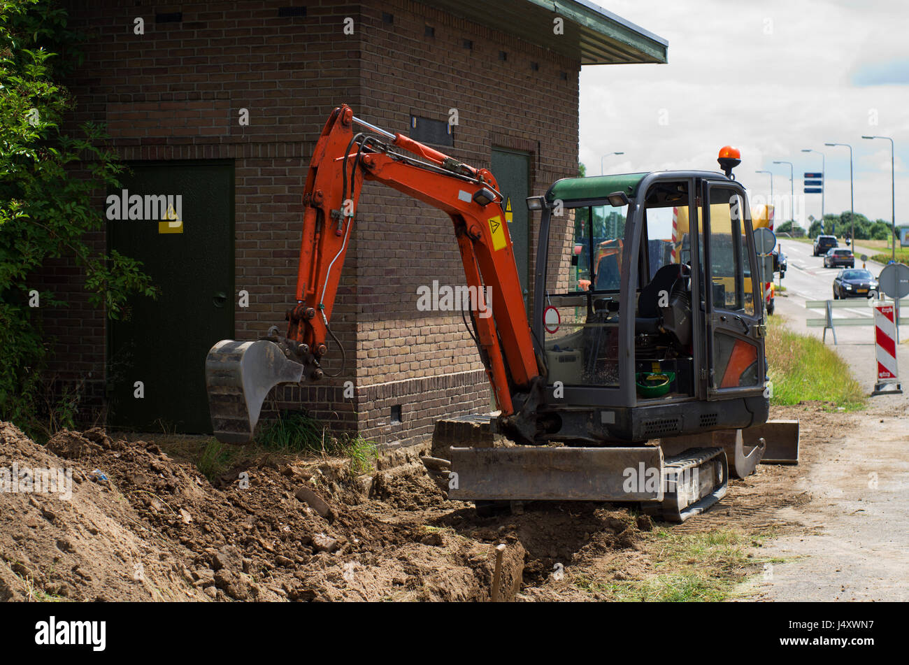 Mini excavator at work site Stock Photo - Alamy