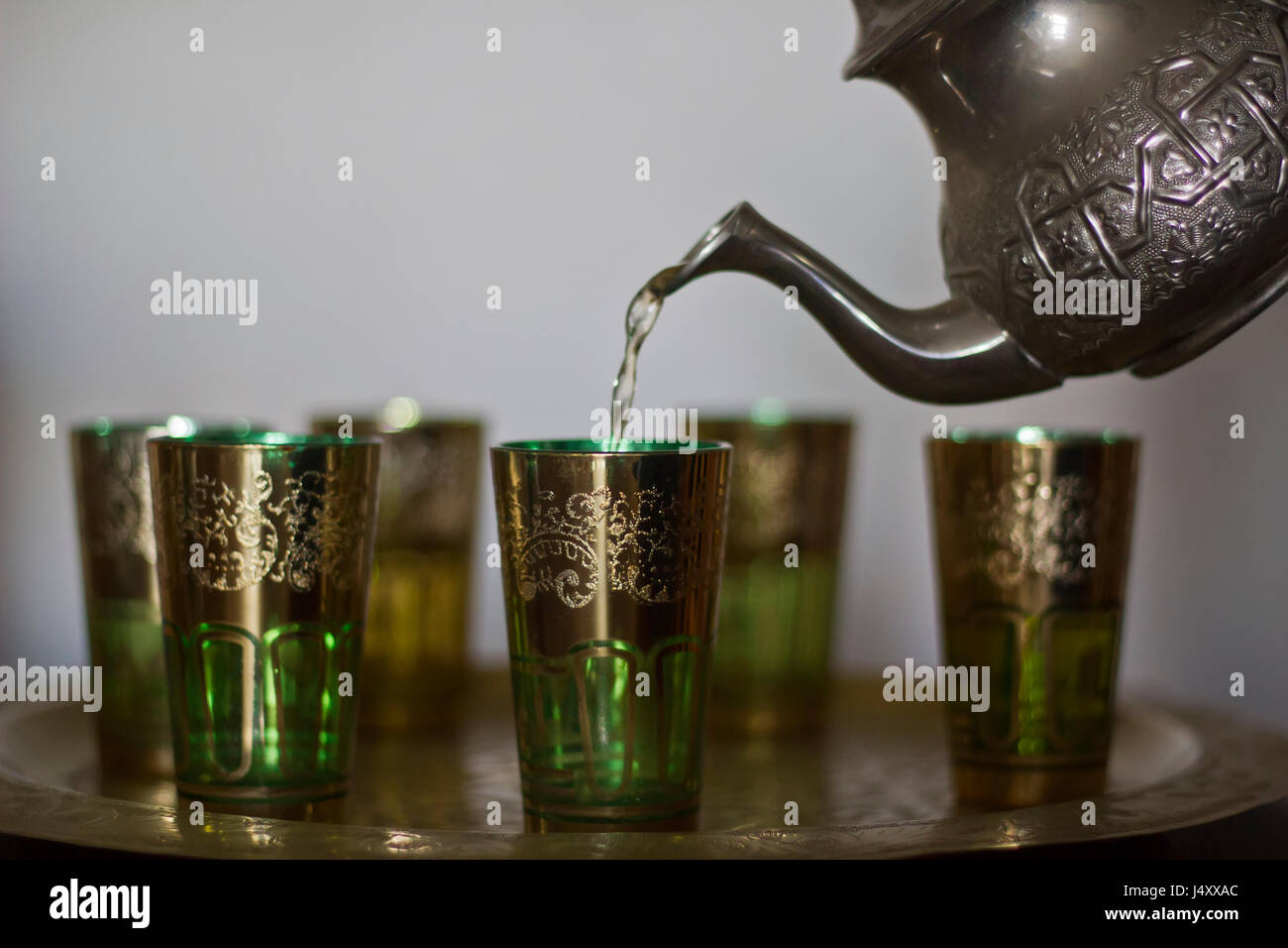 Serving morocco tea in traditional glasses Stock Photo - Alamy