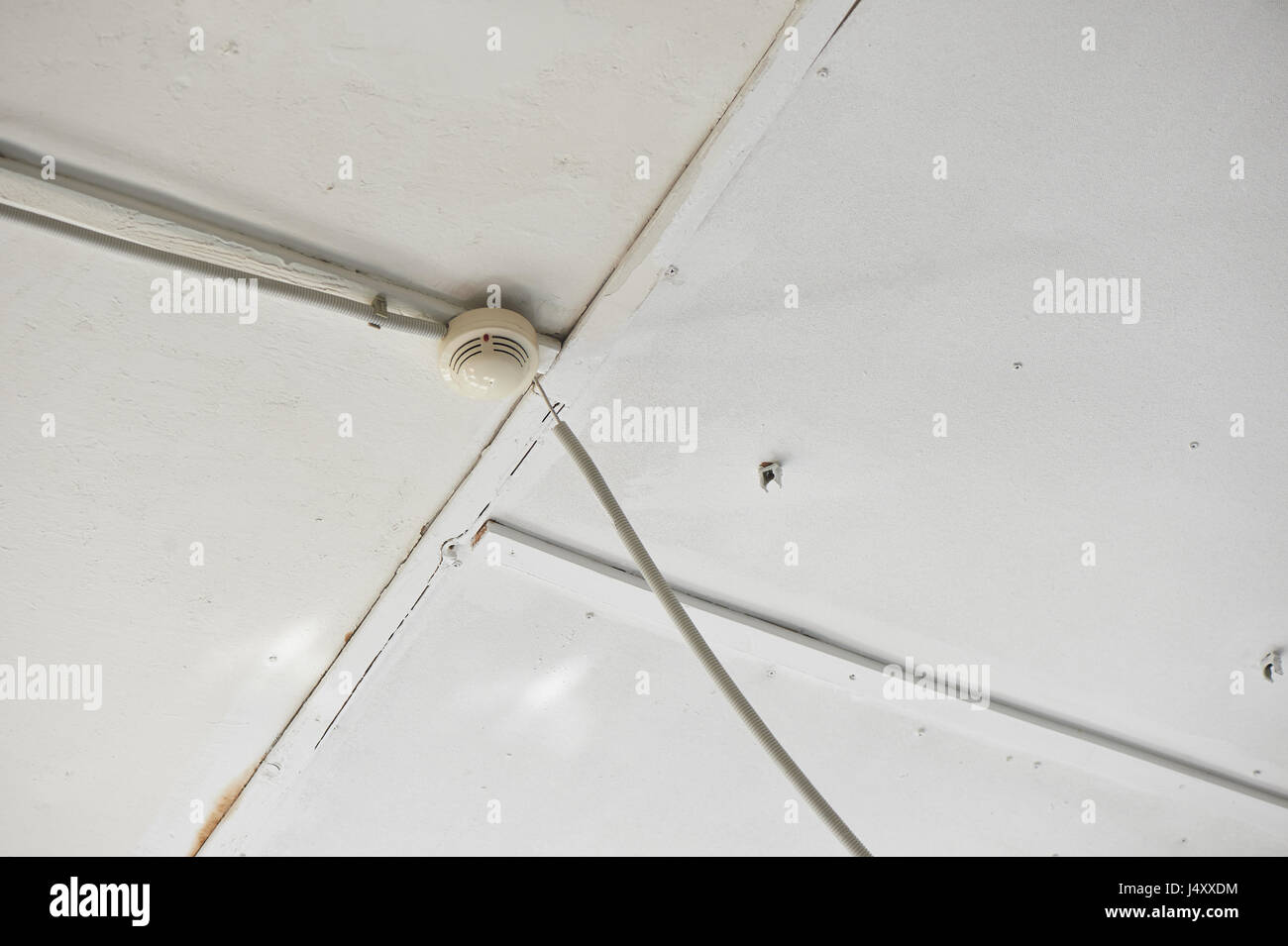 Smoke detector of fire alarm on white wooden ceiling Stock Photo - Alamy
