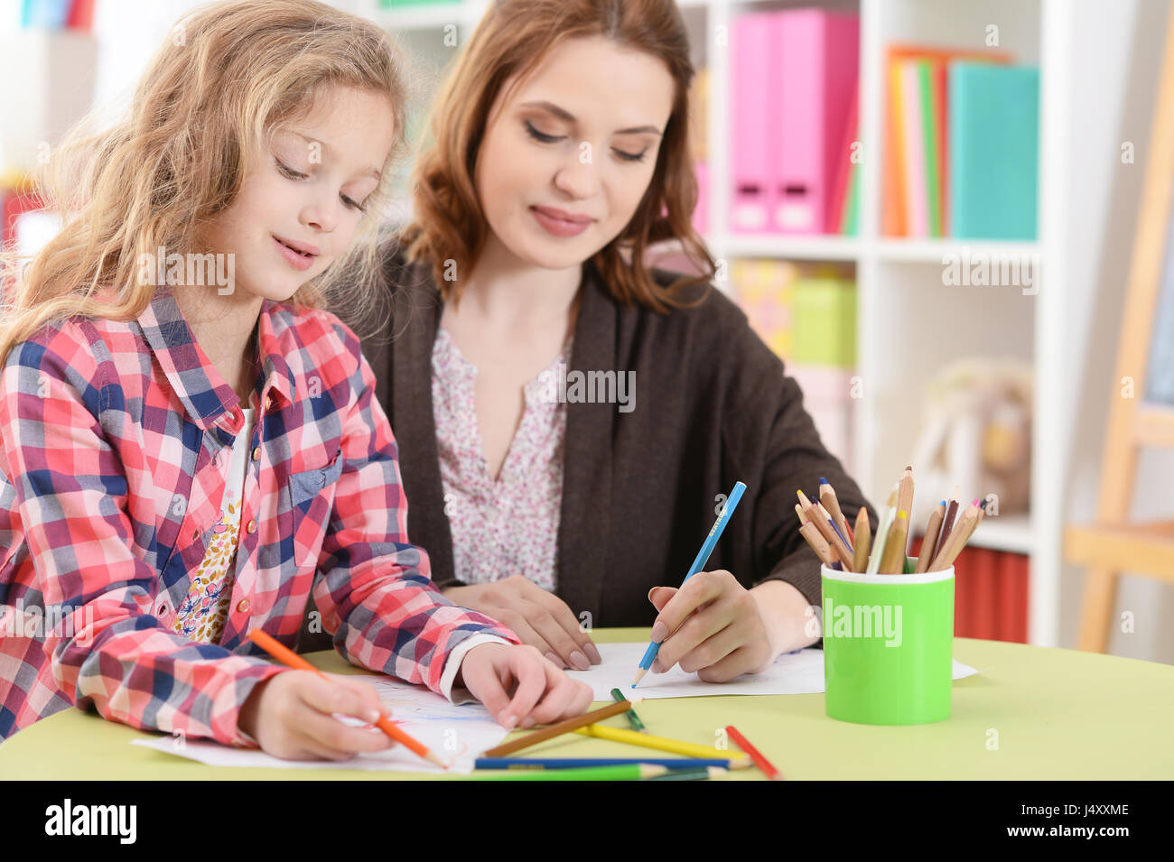 Mom and daughter doing lessons Stock Photo - Alamy