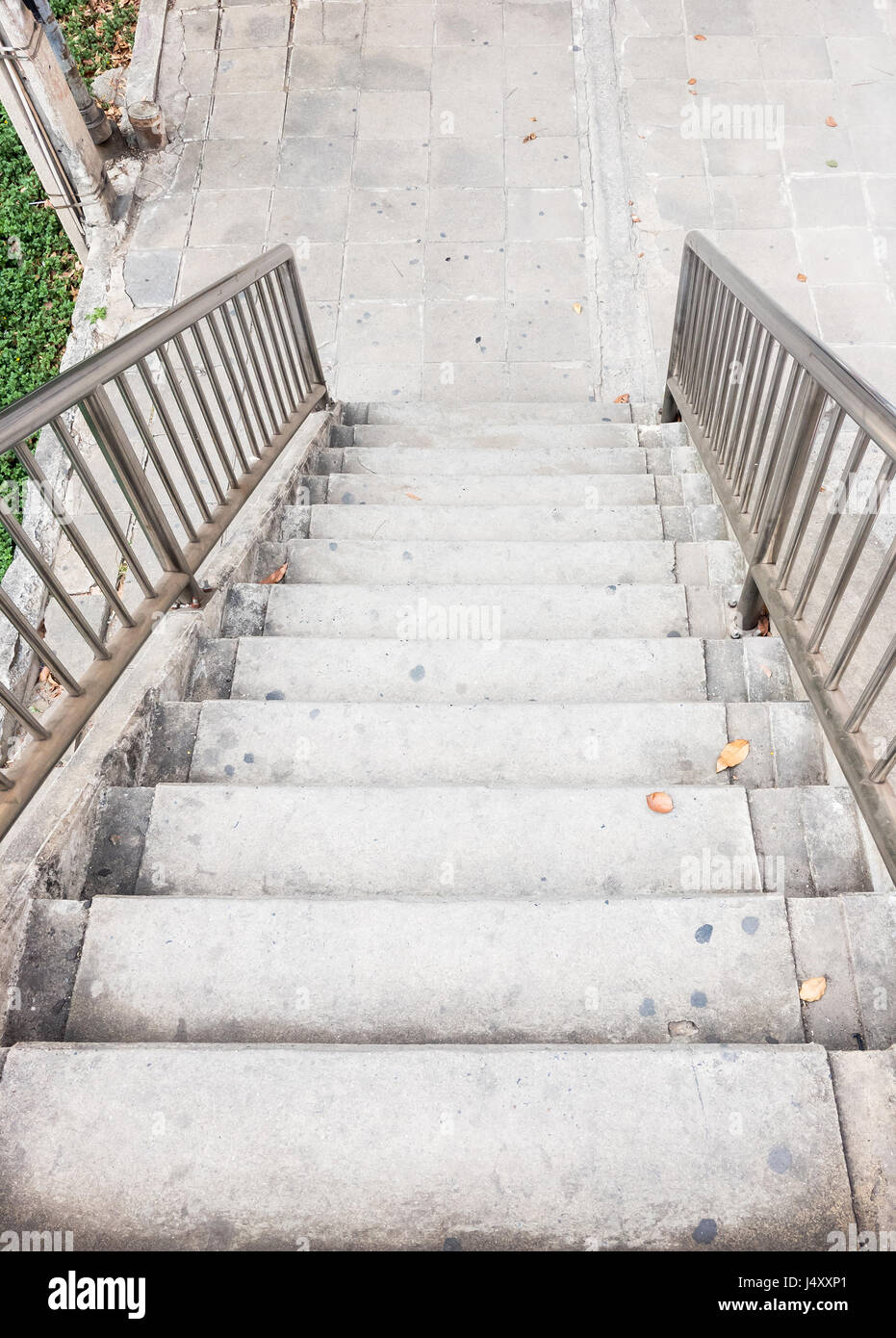 Old concrete staircase with the metal rail of the overpass bridge to ...